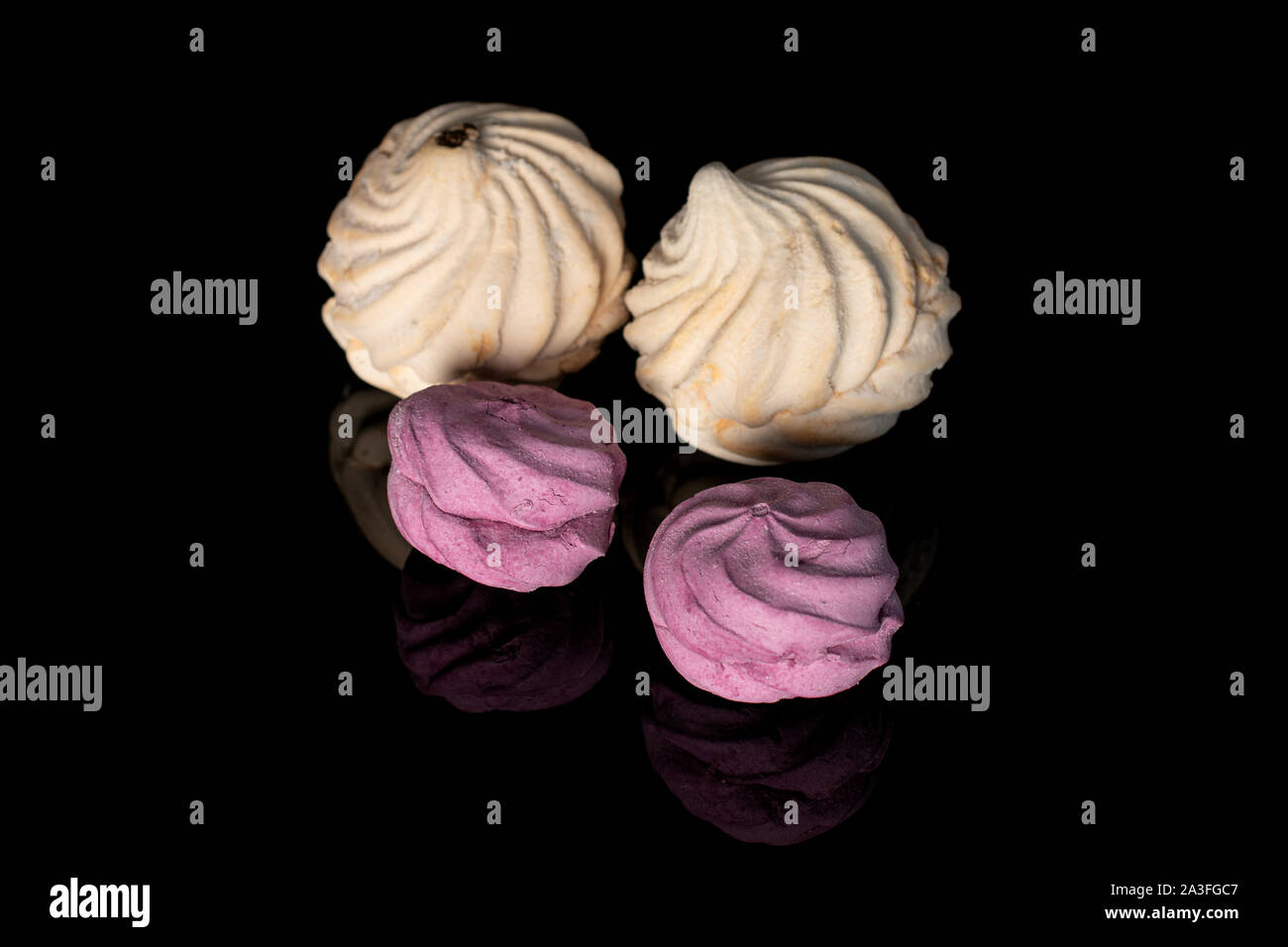 Group of four whole fresh pastel zefir isolated on black glass Stock ...