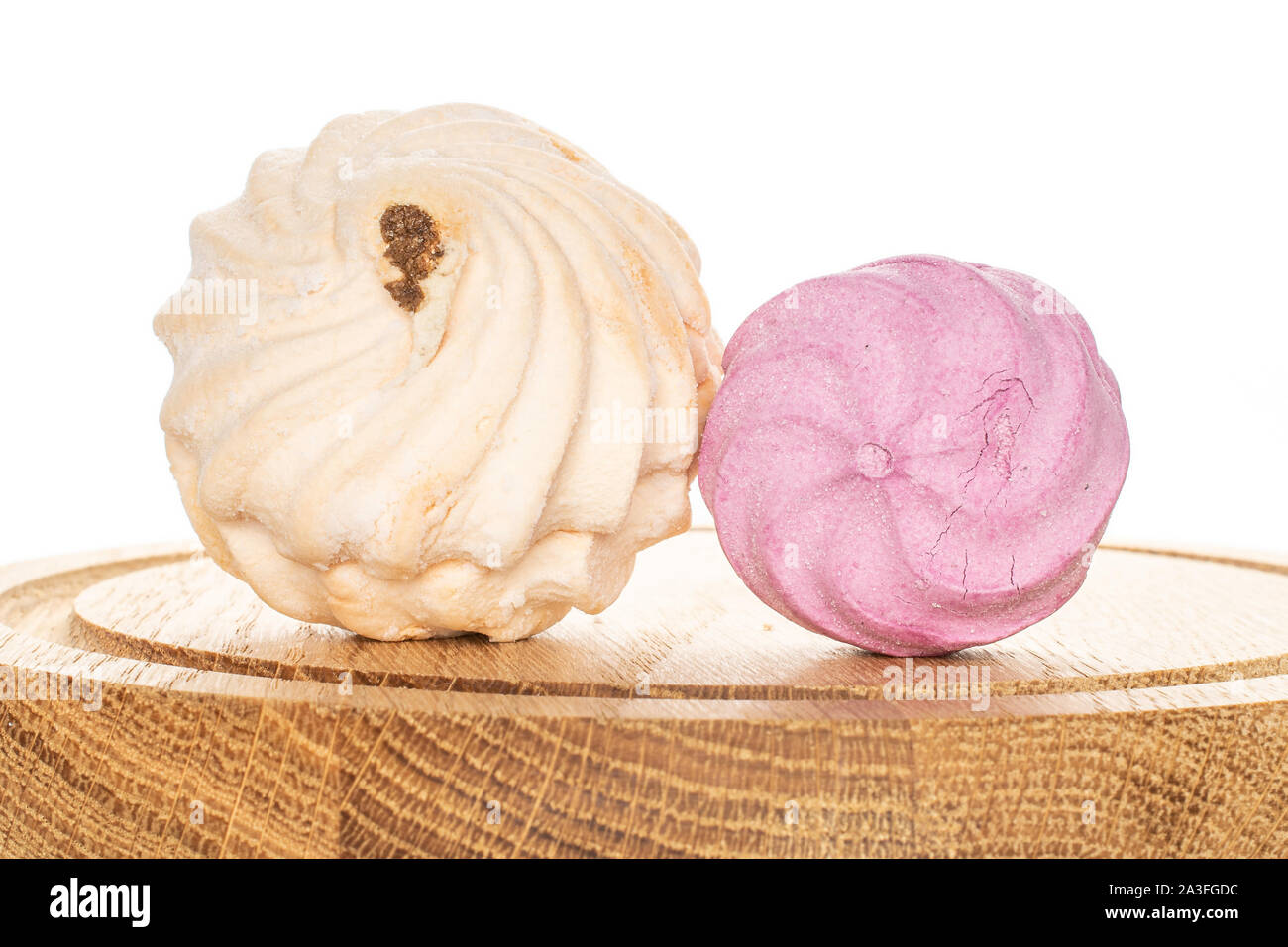 Group of two whole fresh pastel zefir on bamboo plate isolated on white ...