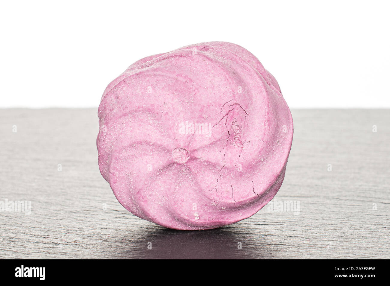 One whole rose fresh pastel zefir on grey stone isolated on white ...