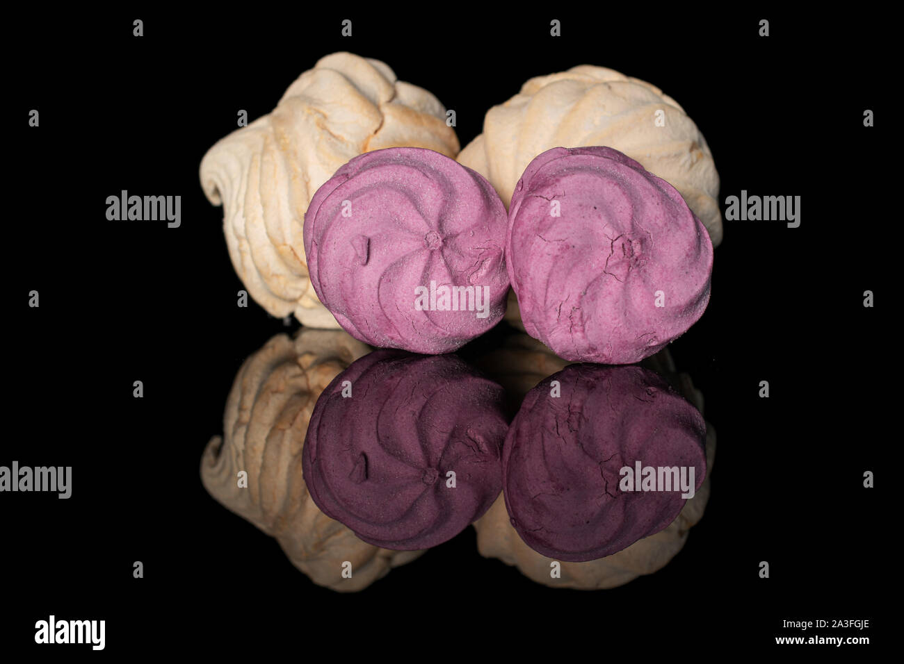 Group of four whole fresh pastel zefir isolated on black glass Stock ...
