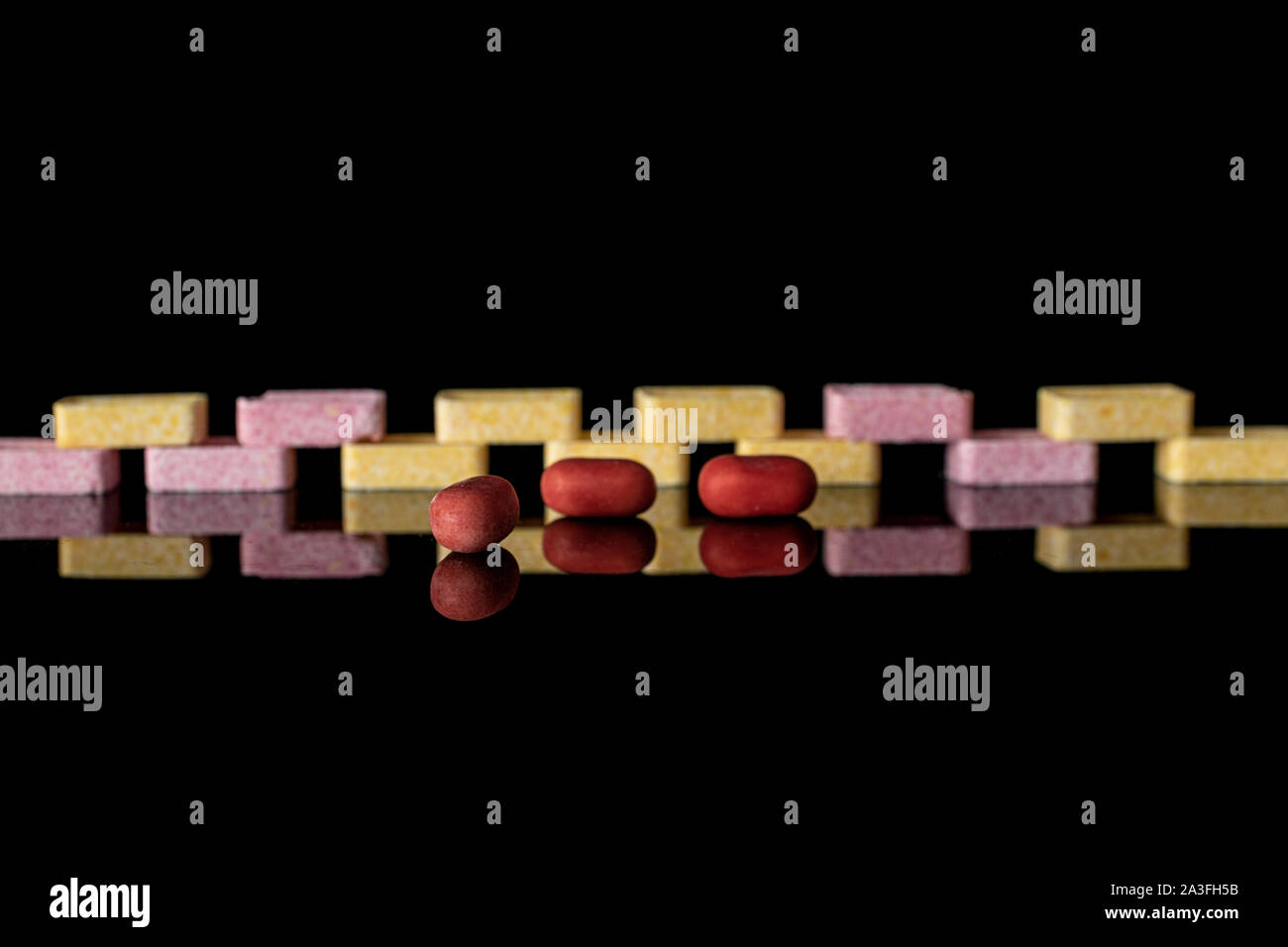 Lot of whole sweet pastel candy wall isolated on black glass Stock ...