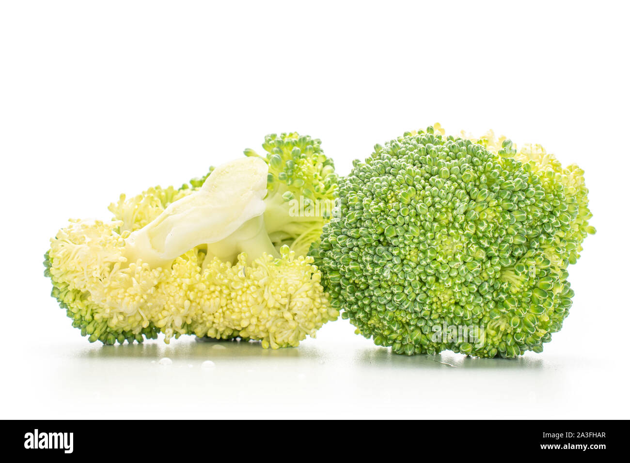 Group of two whole fresh green broccoli pieces isolated on white ...