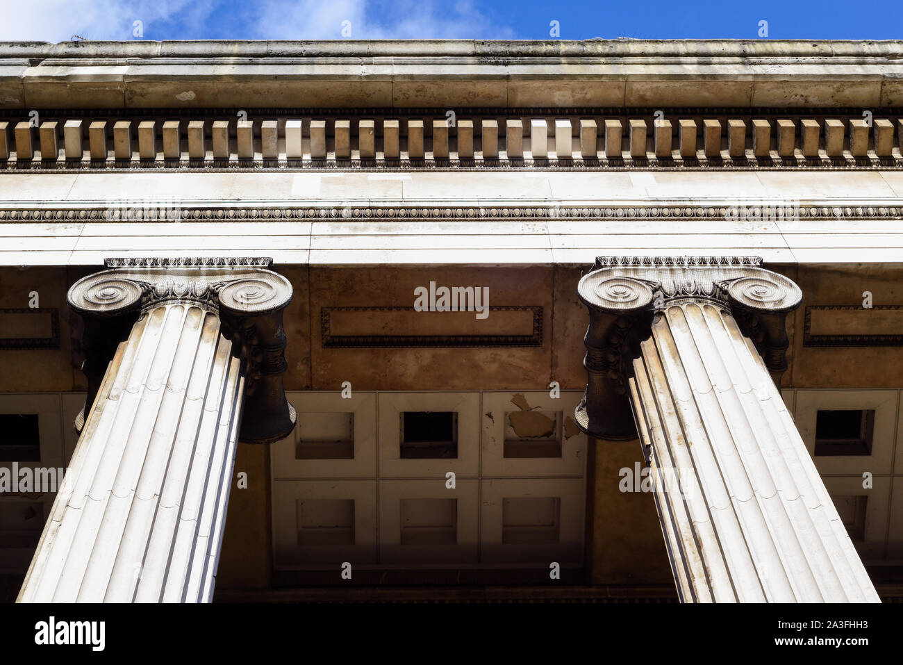 Columns on the exterior of a historic building with detailed stone work ...