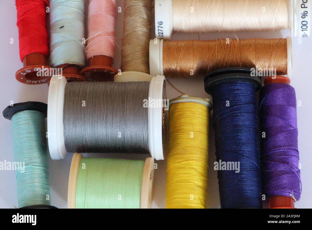 Reels of thread of different colors for sewing Stock Photo - Alamy