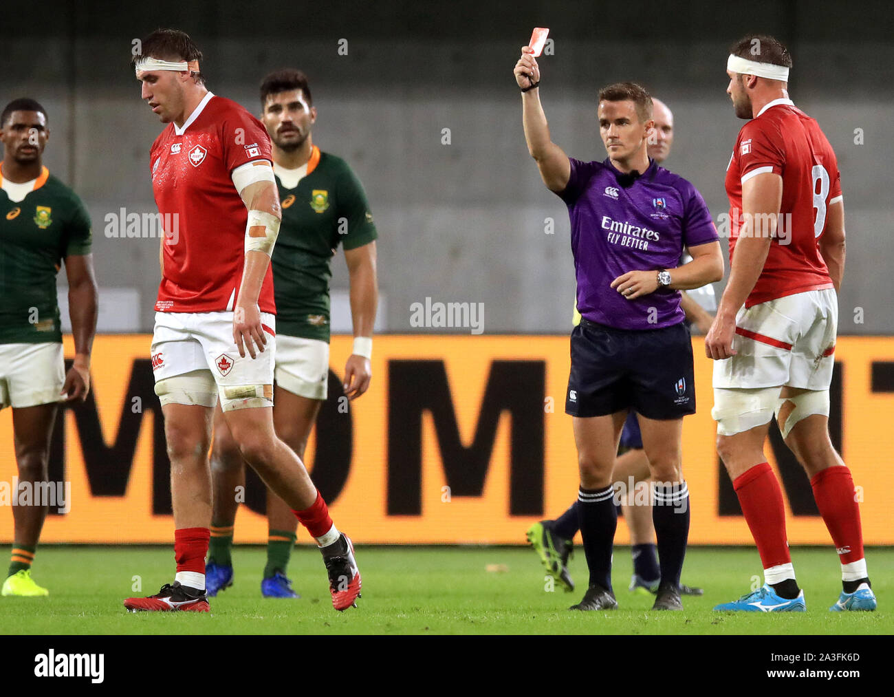 A red card is issued to Canada's Josh Larsen (left) by referee Luke ...