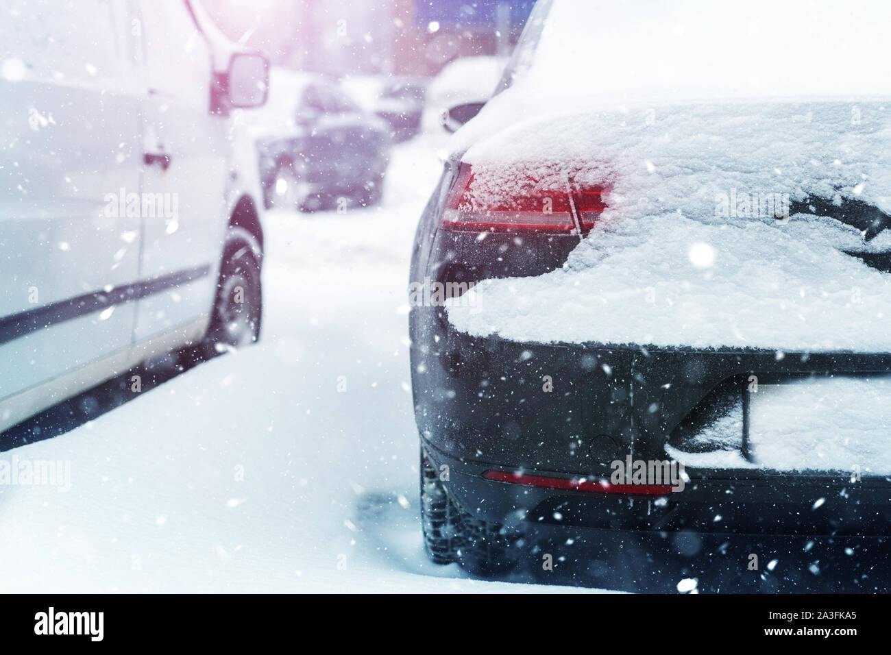 Car parked on city street covered with thick snow layer during ...