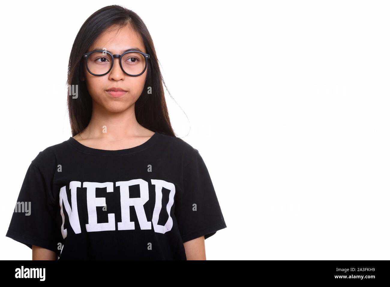 Studio shot of young Asian teenage nerd girl thinking Stock Photo - Alamy