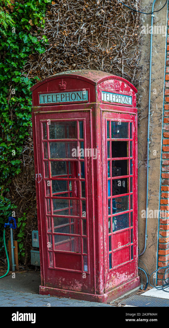 Abandoned Old Red Phone Booth Against Ivy Covered Wall Stock Photo - Alamy