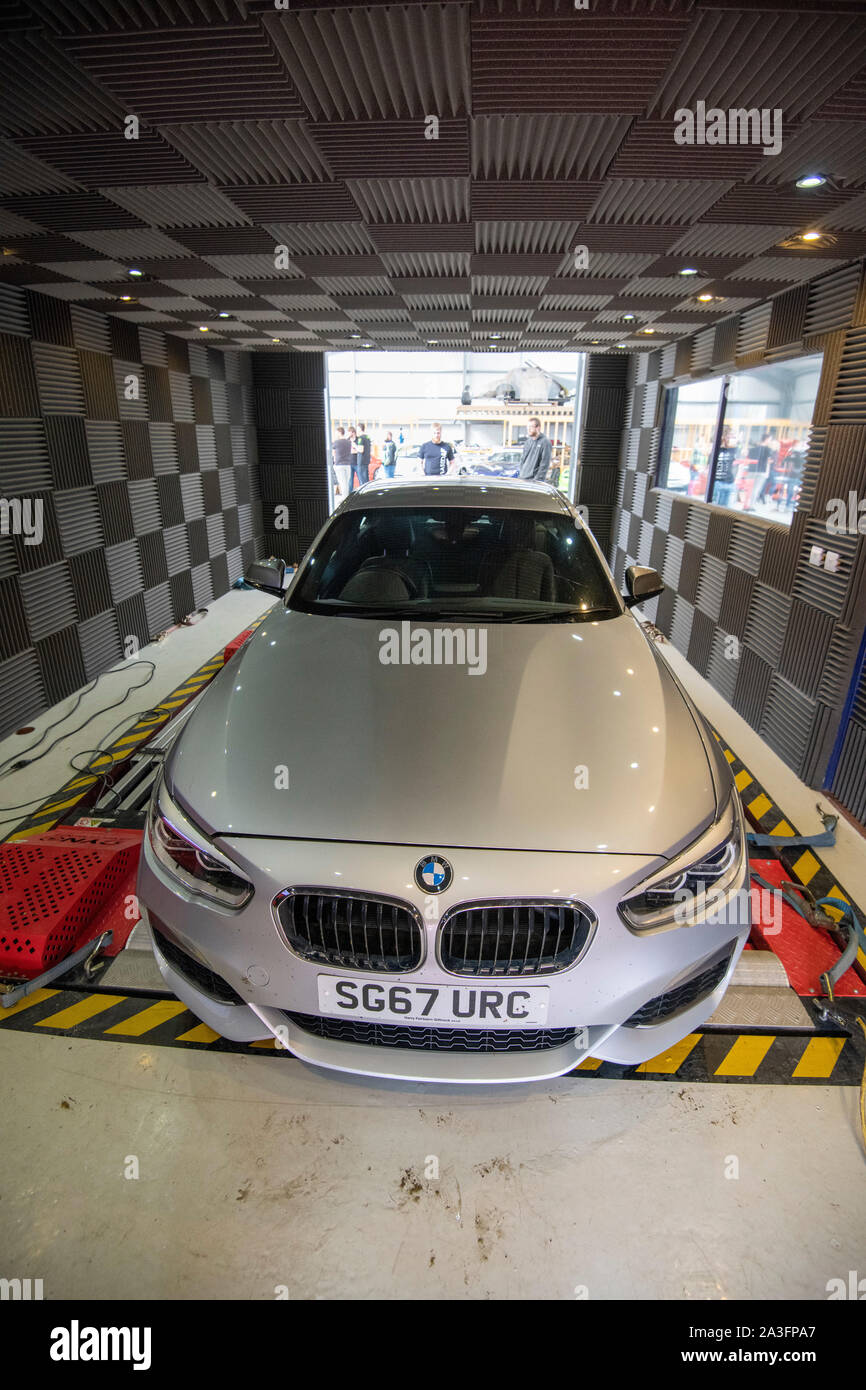 Car on a rolling road being tuned up on a dyno for performance and EDU ... Car on a rolling road being tuned up on a dyno for performance and EDU ...