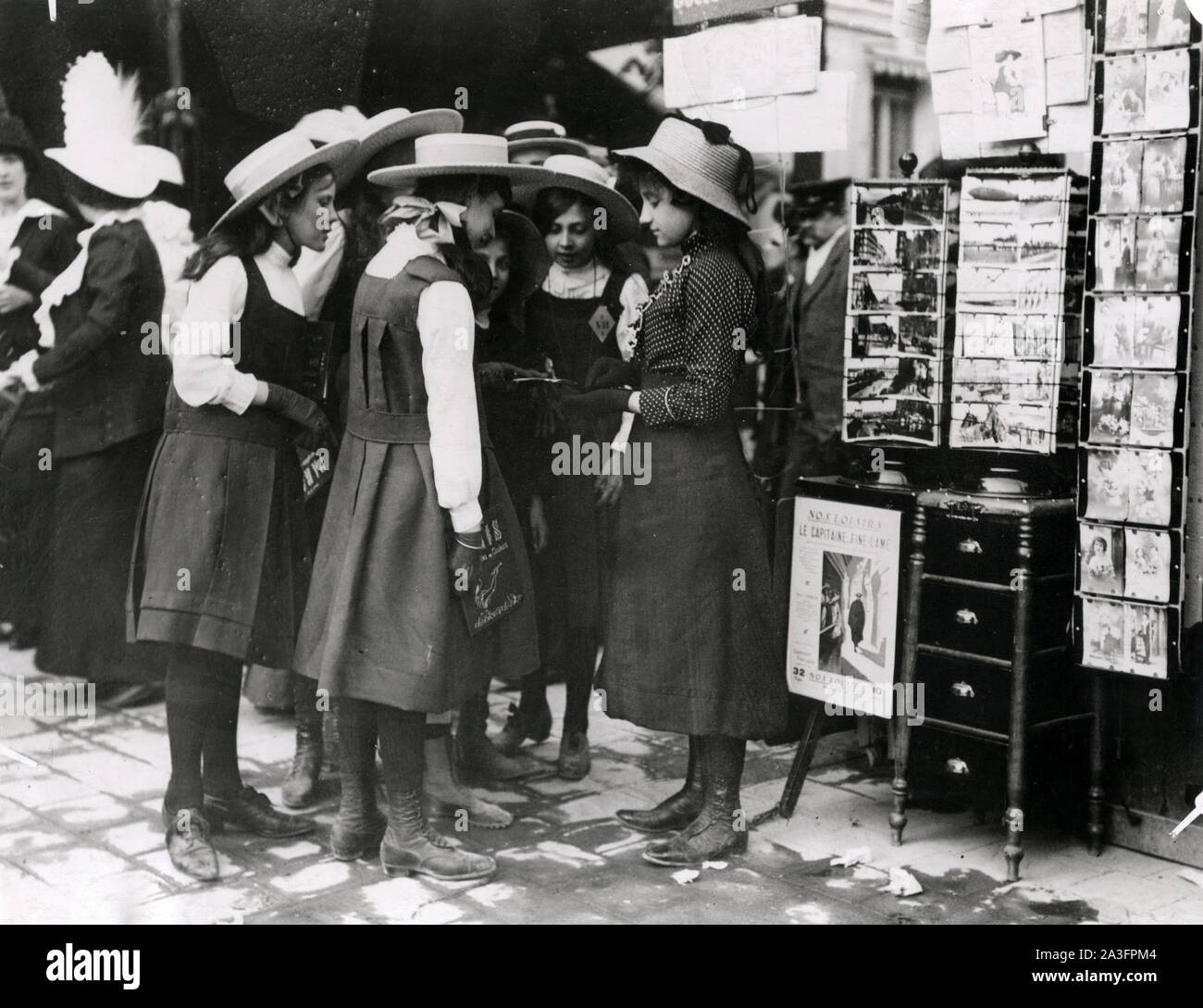 English schoolgirls in uniform buying postcards on a trip to Paris ...