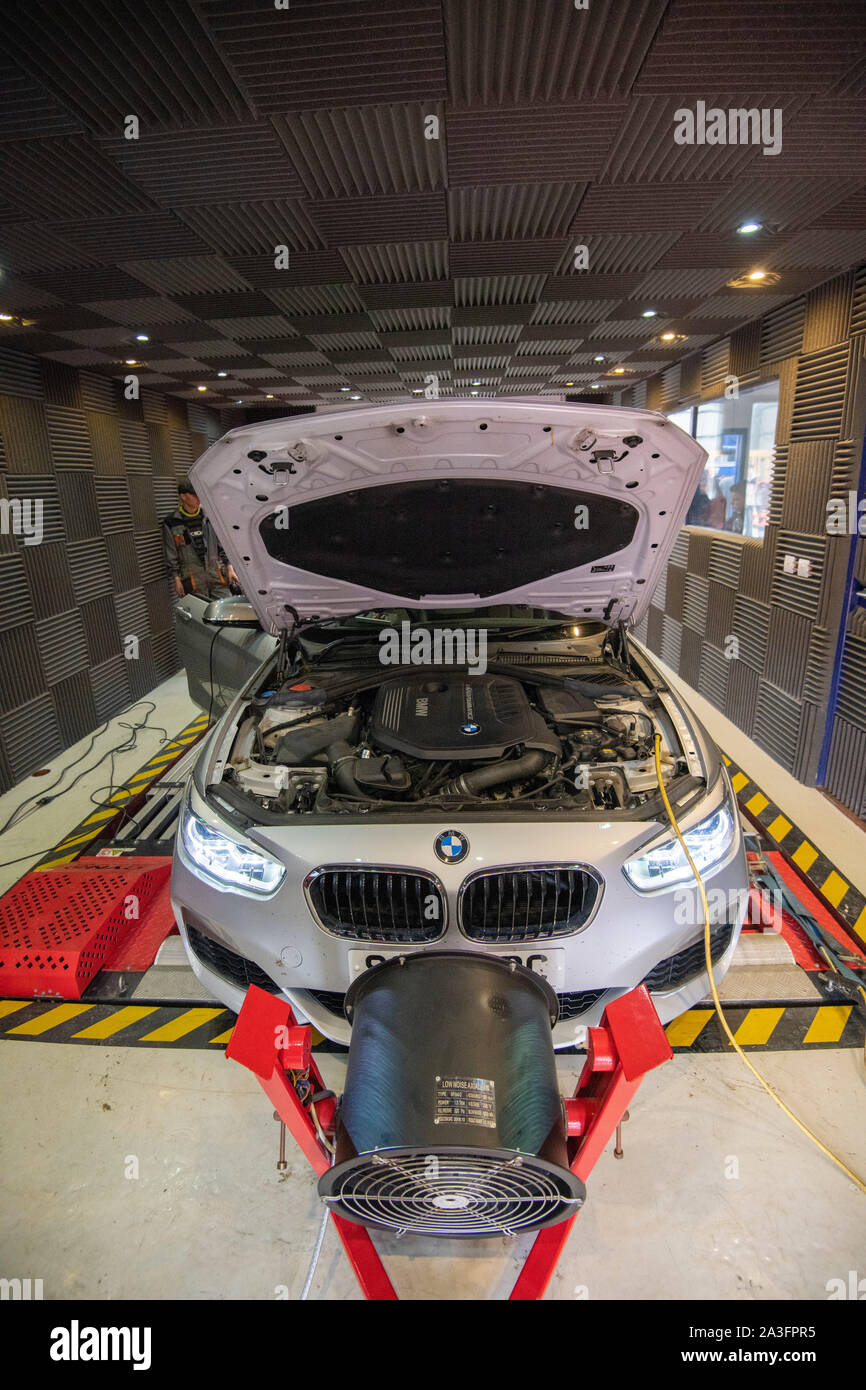 Car on a rolling road being tuned up on a dyno for performance and EDU ...