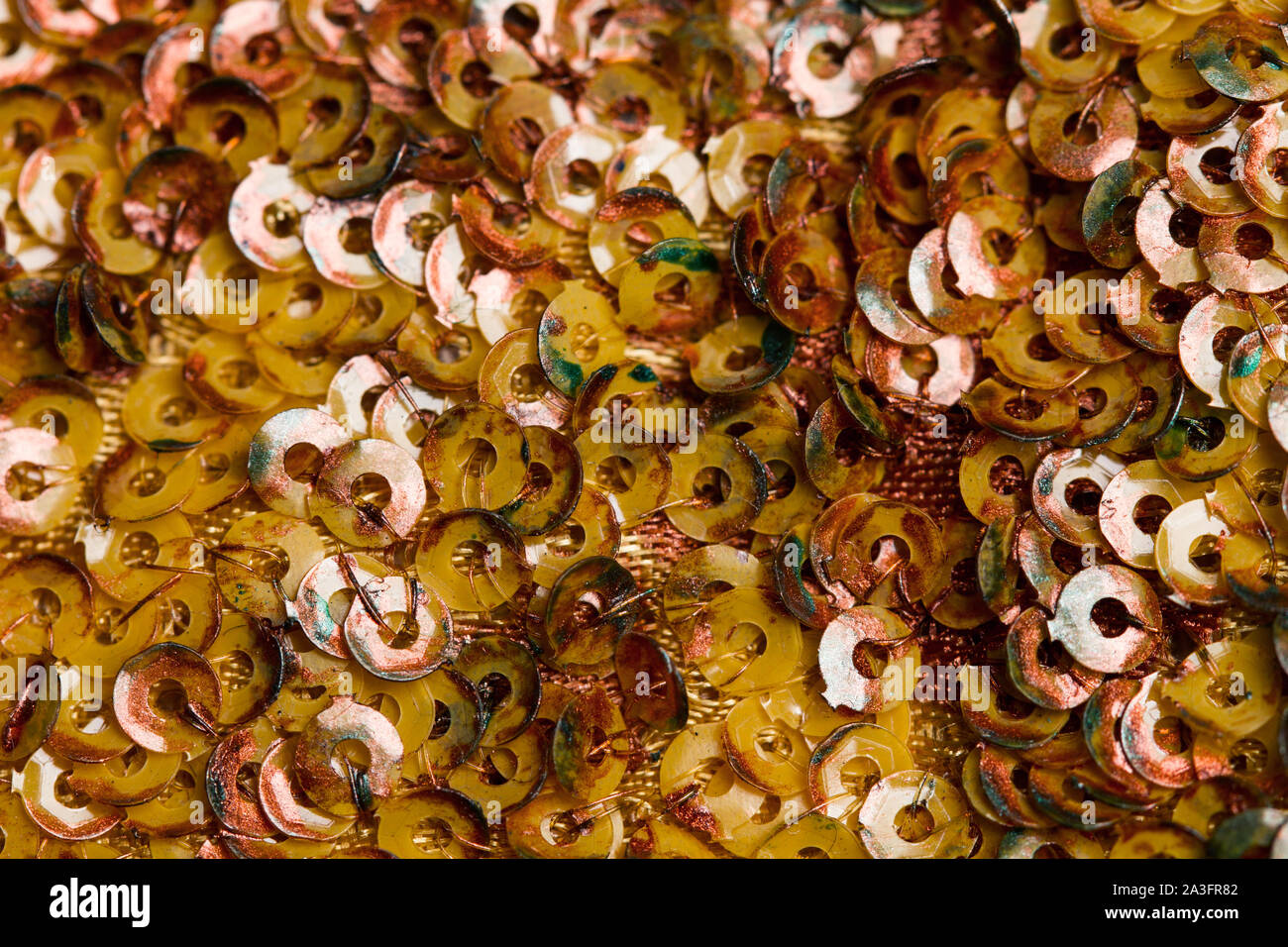 A cloth with yellow sequins in a close up view Stock Photo - Alamy