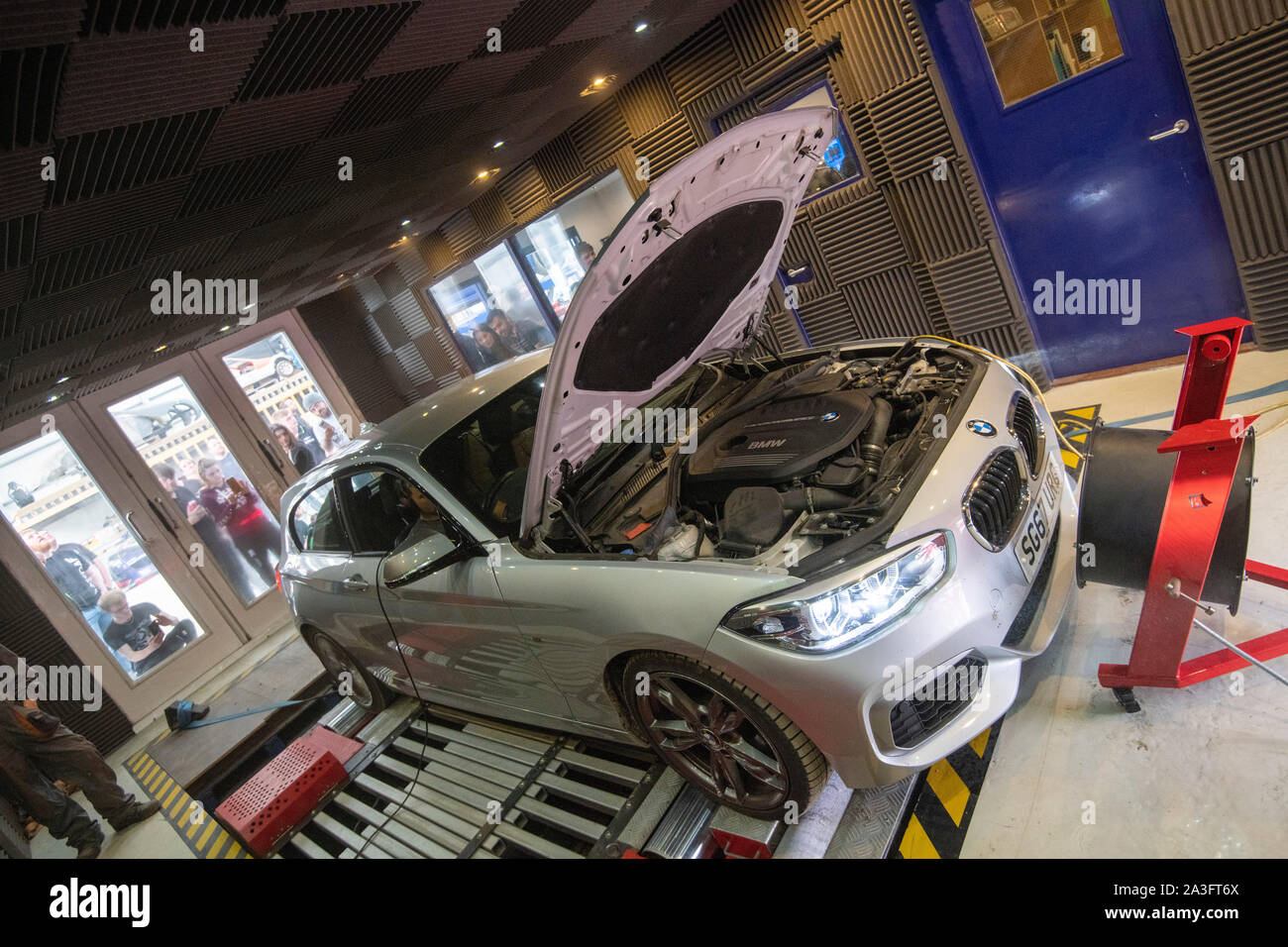 Car on a rolling road being tuned up on a dyno for performance and EDU ...