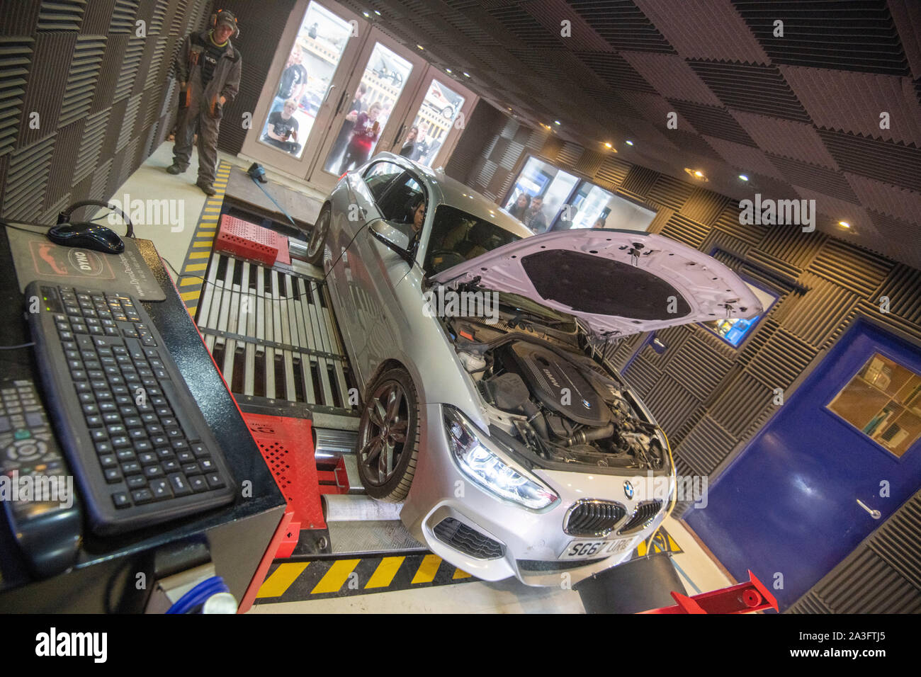 Car on a rolling road being tuned up on a dyno for performance and EDU ...