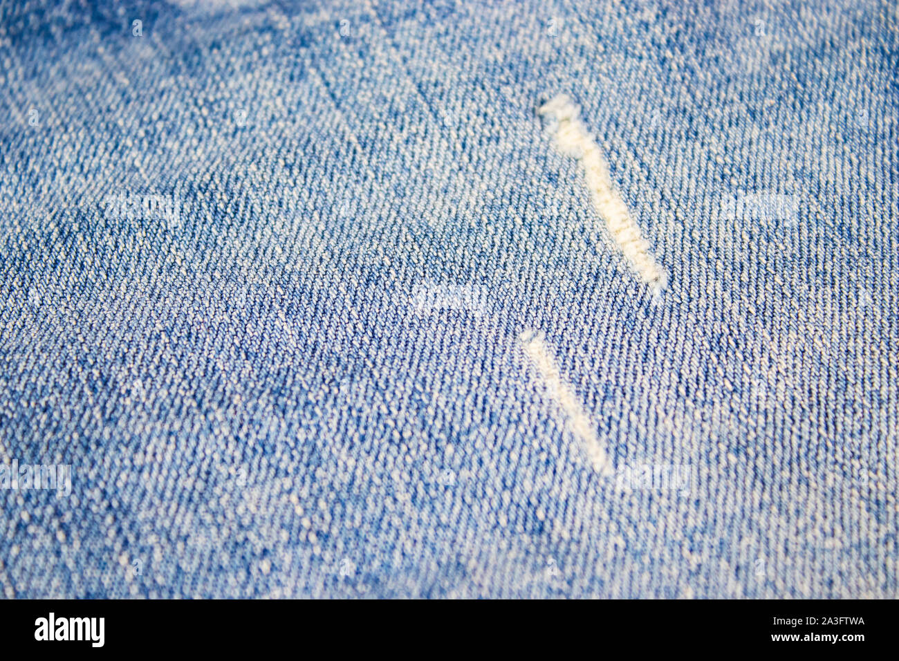 Ripped destroyed in wash blue denim jeans. isolated background Stock ...