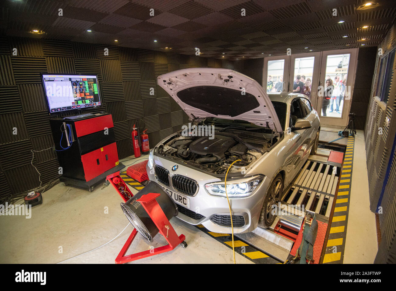 Car on a rolling road being tuned up on a dyno for performance and EDU ...