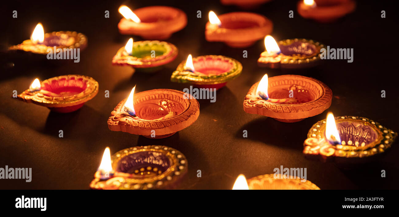 Happy Diwali. Clay diya candles illuminated in Dipavali, Hindu festival ...