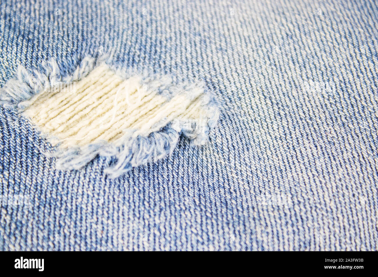 Ripped destroyed in wash blue denim jeans. isolated background Stock ...