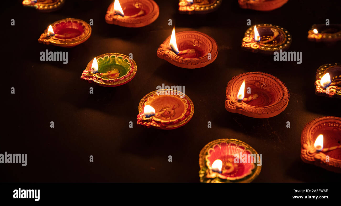 Happy Diwali. Clay diya candles illuminated in Dipavali, Hindu festival ...