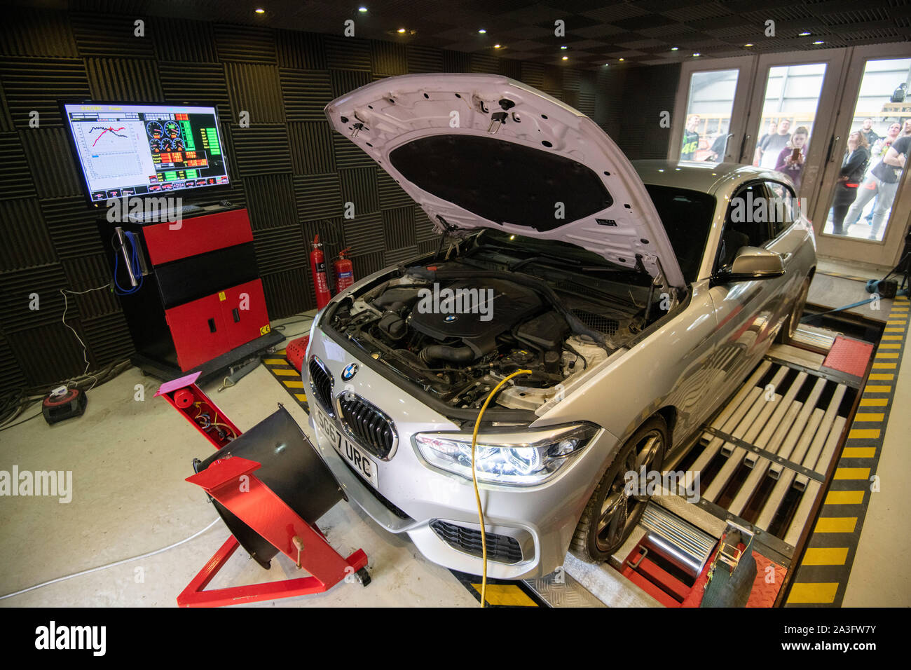 Car on a rolling road being tuned up on a dyno for performance and EDU ...