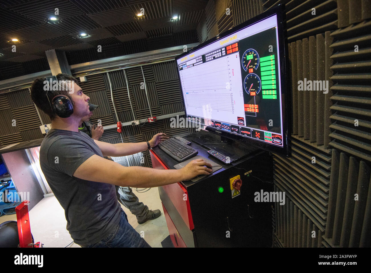 Car on a rolling road being tuned up on a dyno for performance and EDU ... Car on a rolling road being tuned up on a dyno for performance and EDU ...
