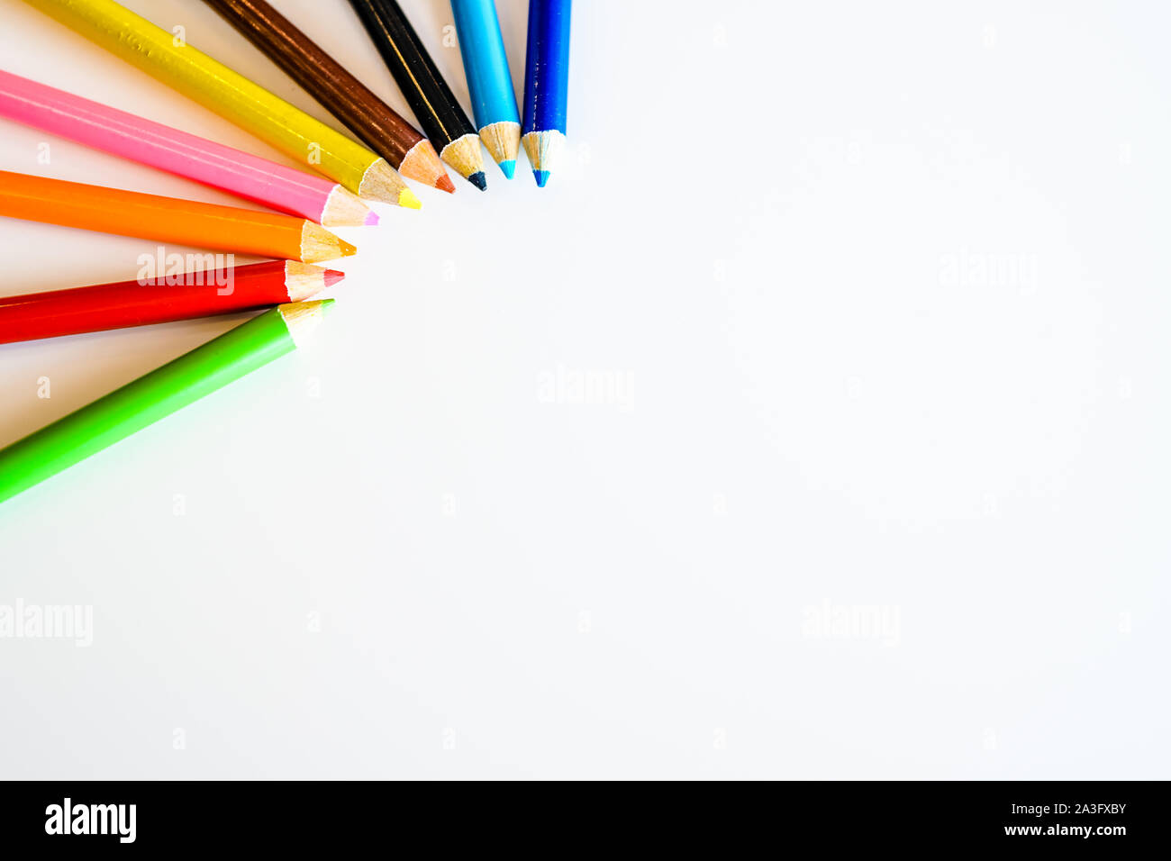 Line of color pencils isolated on white background. Close up. Copy ...