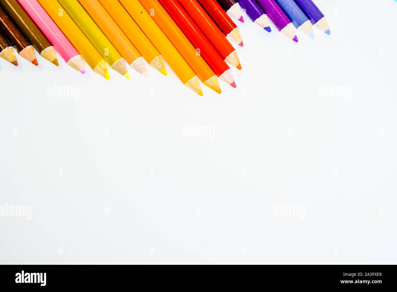 Line of color pencils isolated on white background. Close up. Copy ...
