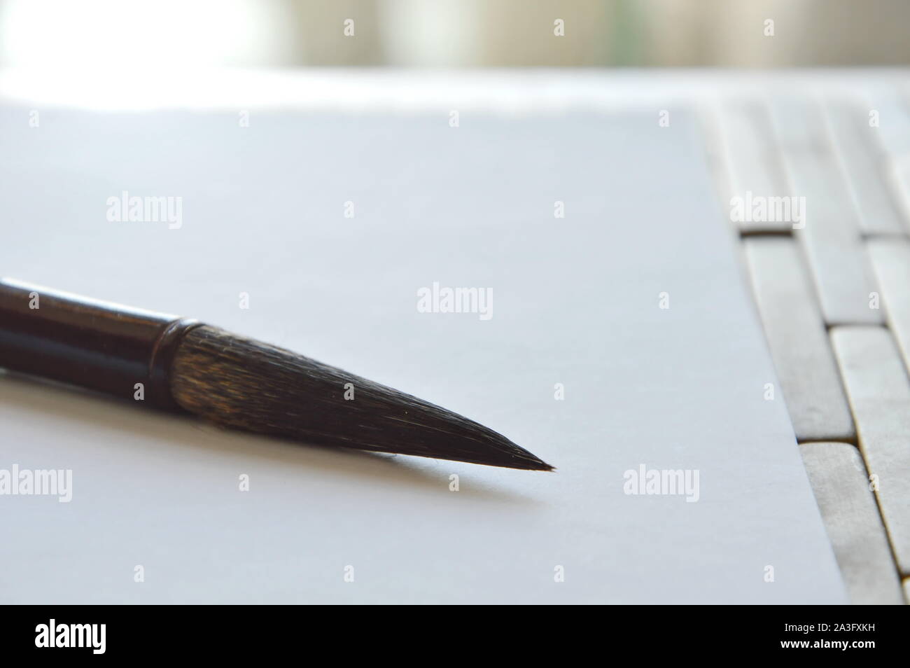 Chinese calligraphy on white paper Stock Photo - Alamy