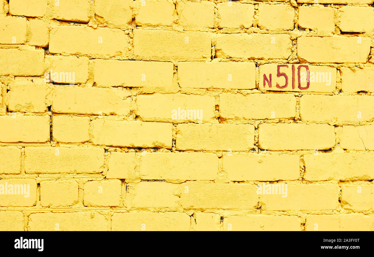 Painted brick wall in yellow or living coral color background texture ...