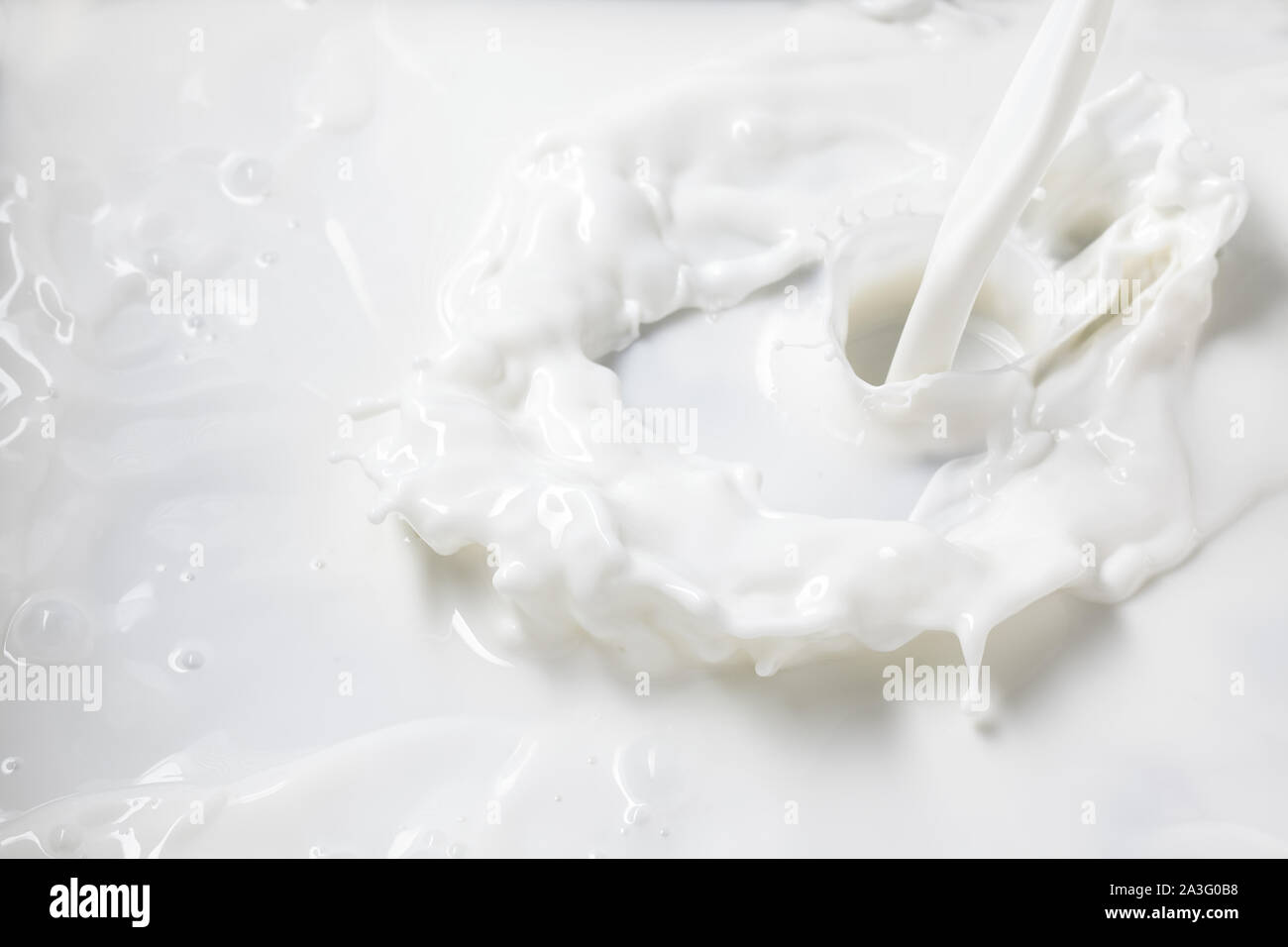 Top view of pouring milk splash with crown Stock Photo - Alamy