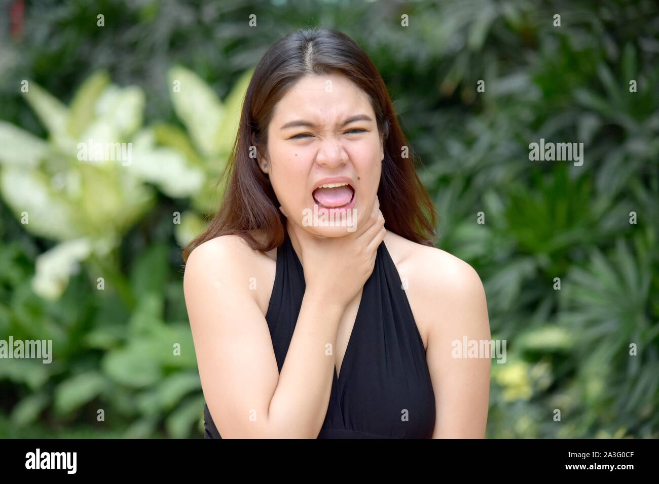 A Choking Pretty Asian Female Stock Photo - Alamy