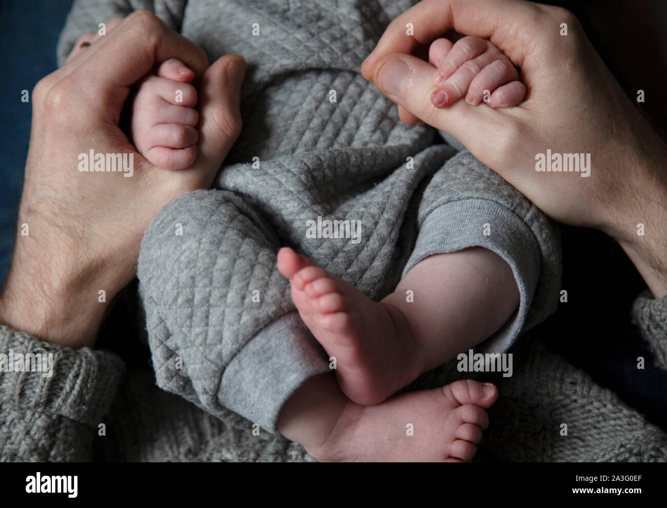 Father hands holding cute baby feet hi-res stock photography and images ...