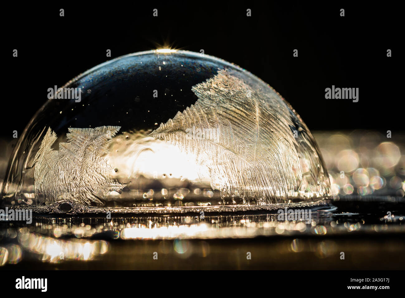 Frozen bubble of bubble blower with ice crystals pattern Stock Photo ...
