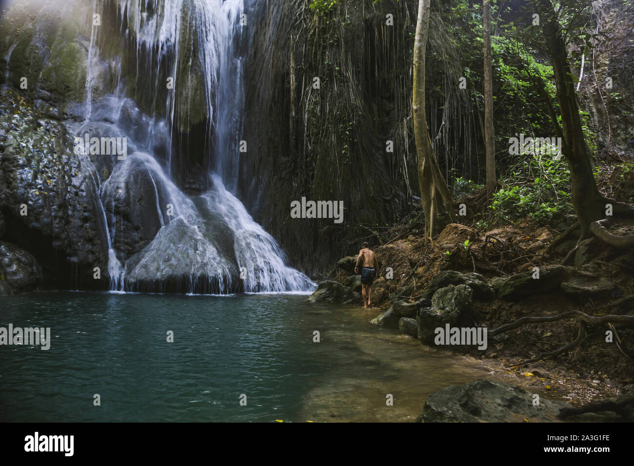 Young man near waterfall hi-res stock photography and images - Alamy