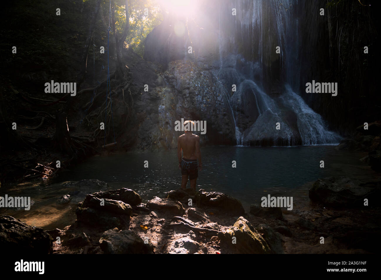 Man standing near waterfall Stock Photo - Alamy