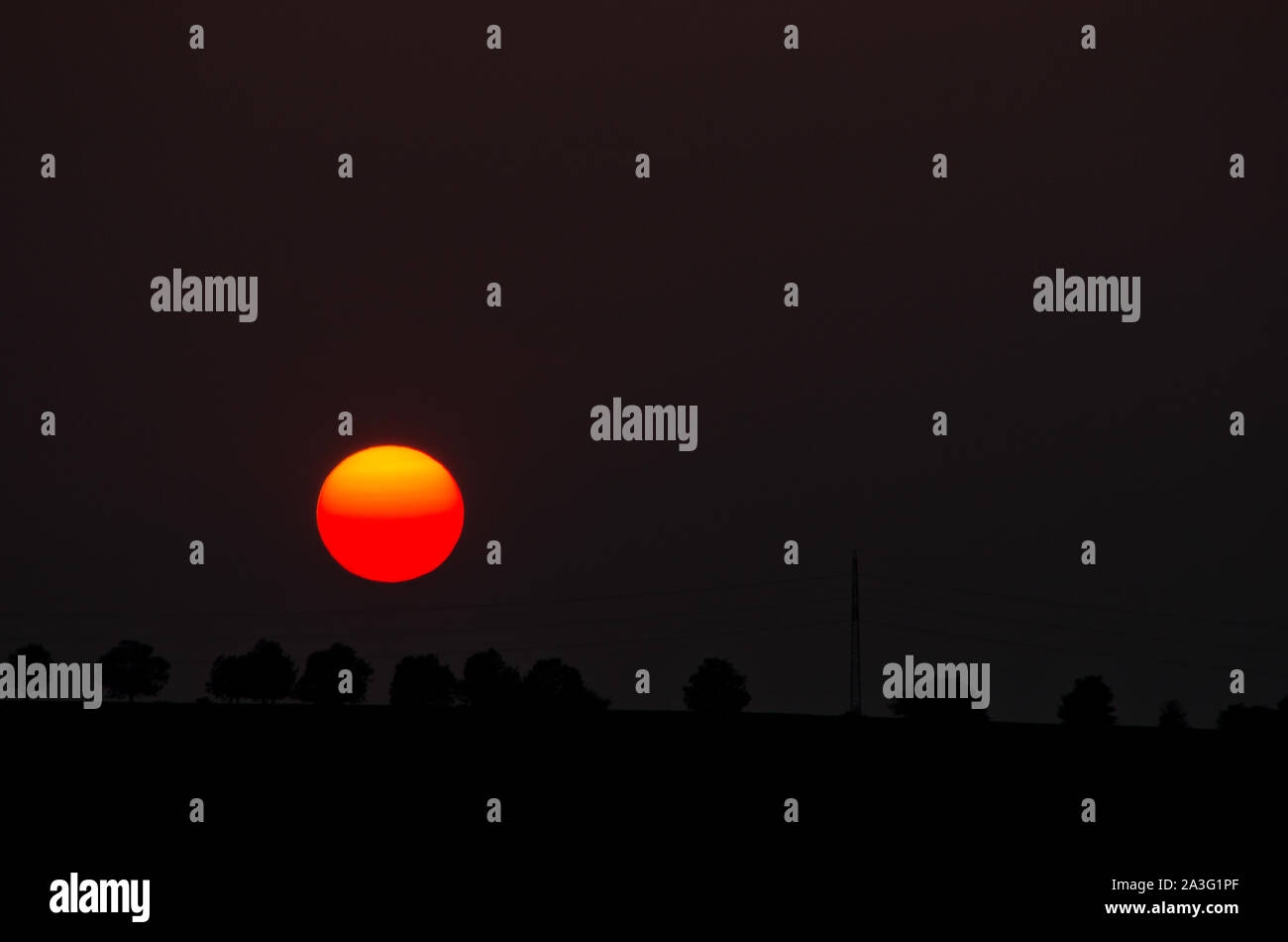Orange sunset on horizon with big orange sun Stock Photo - Alamy