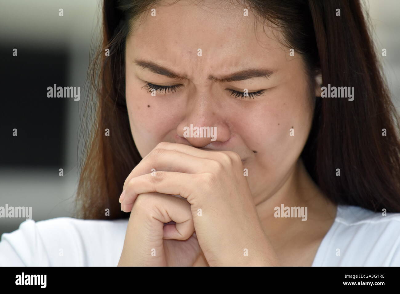 A Crying Youthful Filipina Female Stock Photo - Alamy
