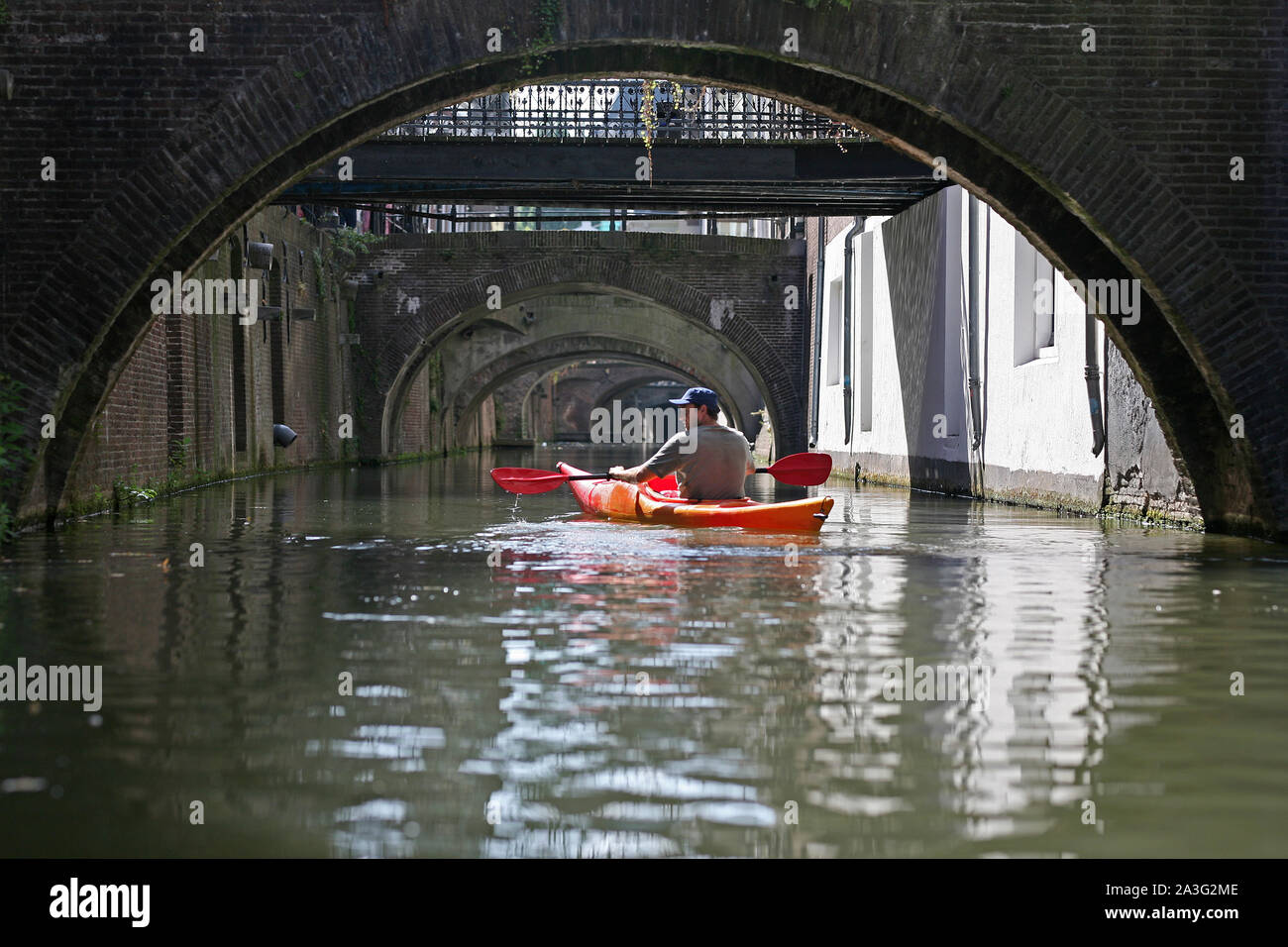 A man taking a break under a bridge after an afternoon of kayaking ...
