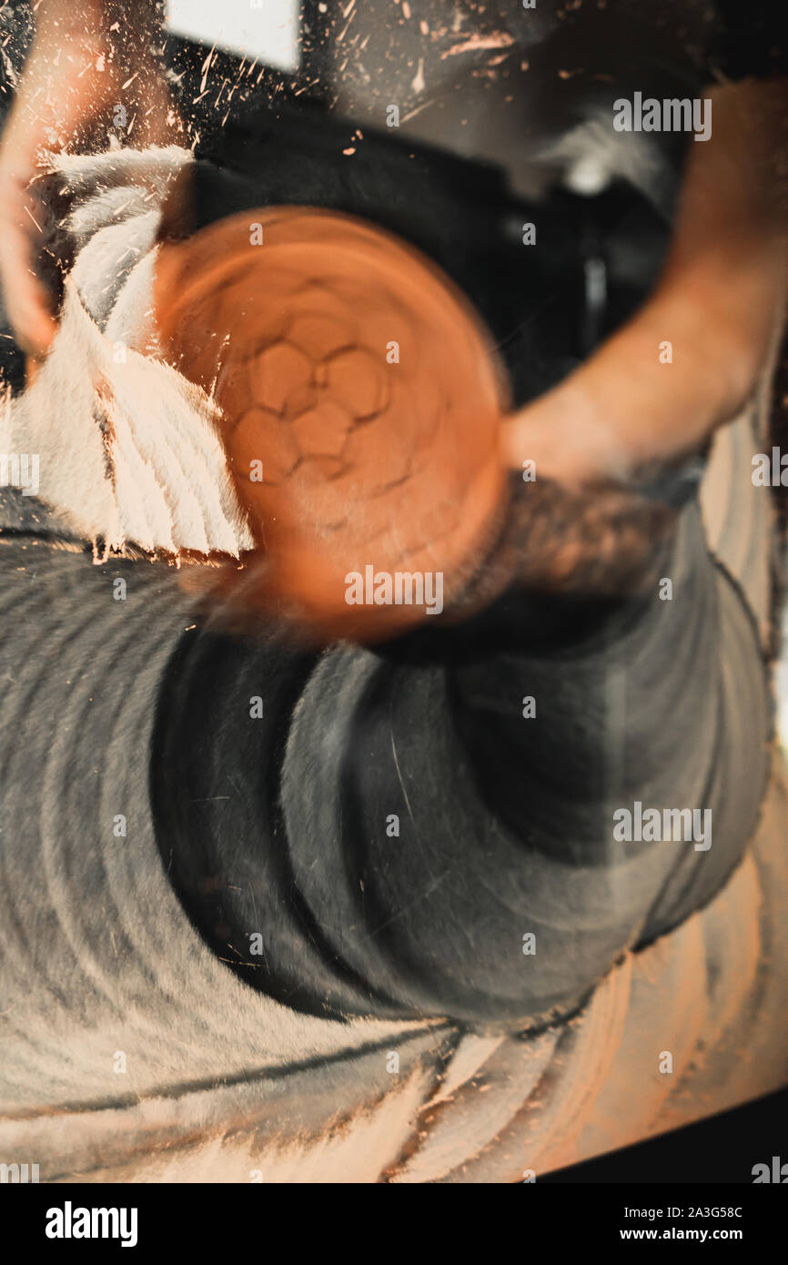 Mechanic using professional glass polishing tool to remove scratches ...