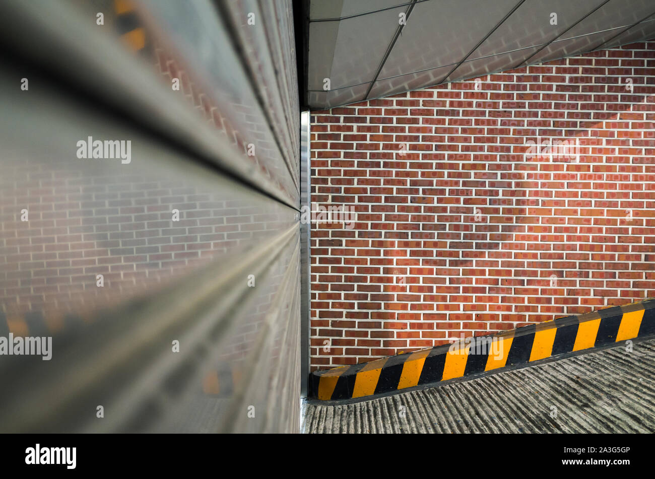 Abstract urban background with closed underground garage door and red ...