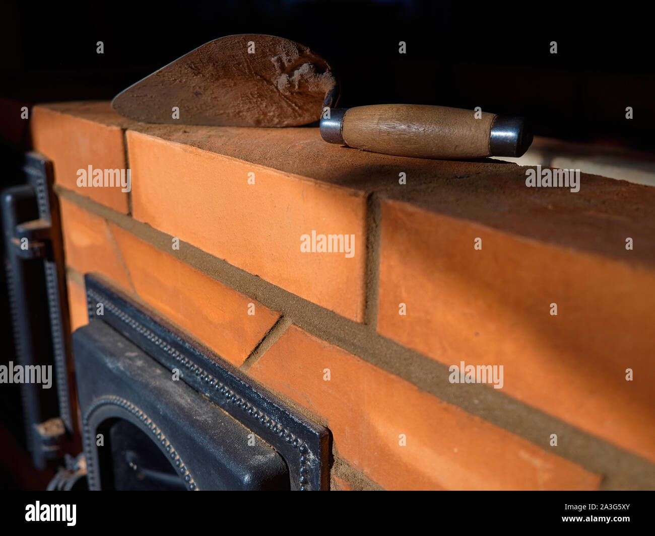 Phased construction of a red ceramic brick stove Stock Photo - Alamy