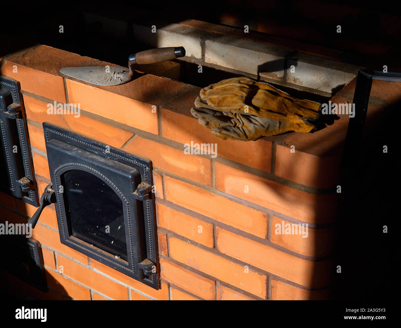 Phased construction of a red ceramic brick stove Stock Photo - Alamy