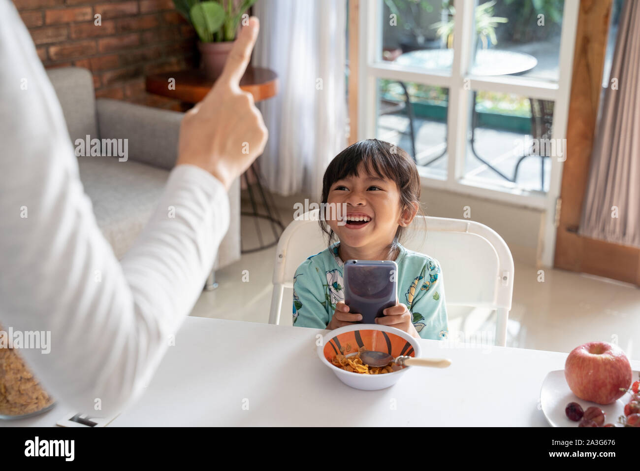 portrait of a mother get angry with stubborn kid using mobile phone ...