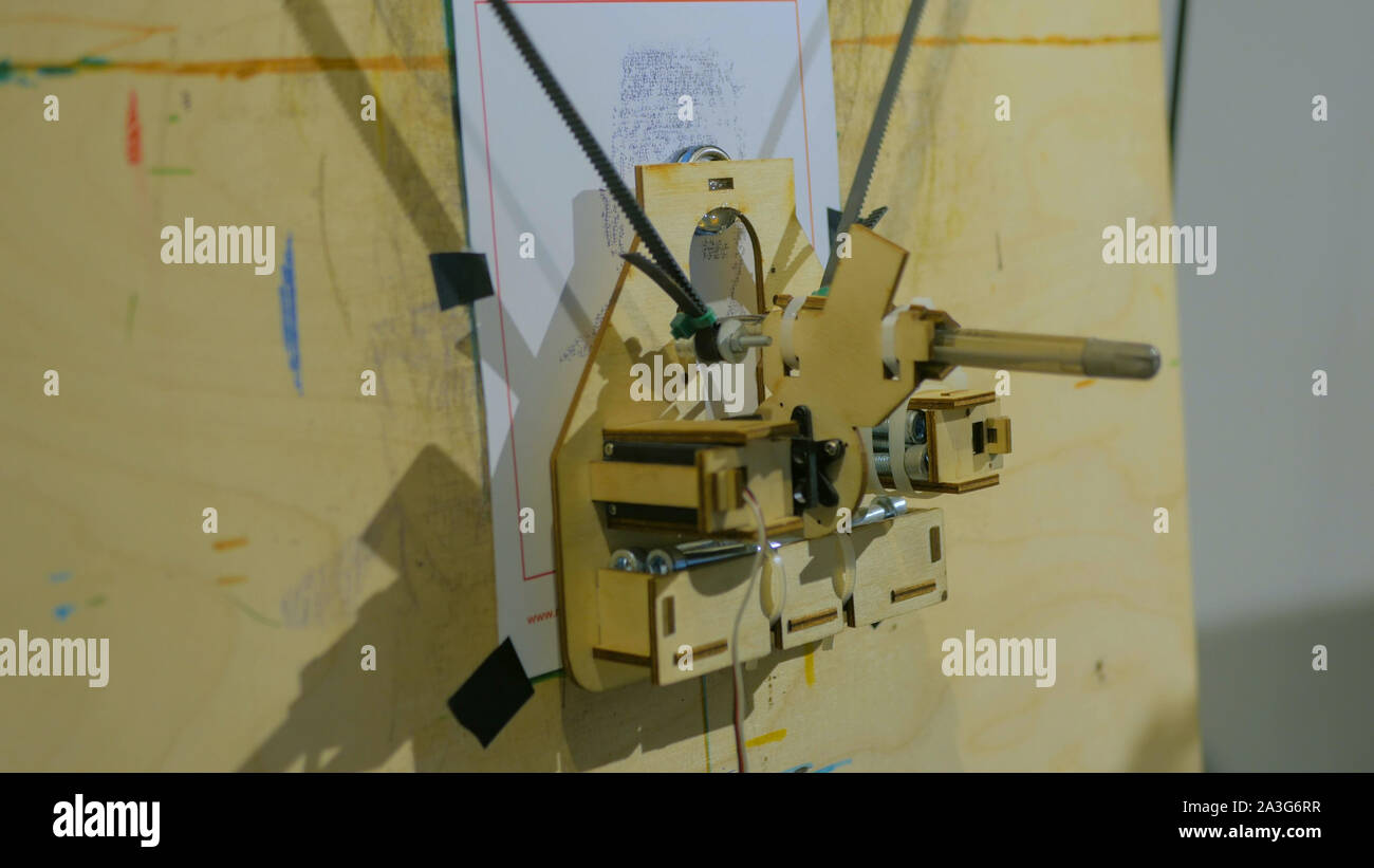 Robotic arm with pen drawing portrait Stock Photo - Alamy