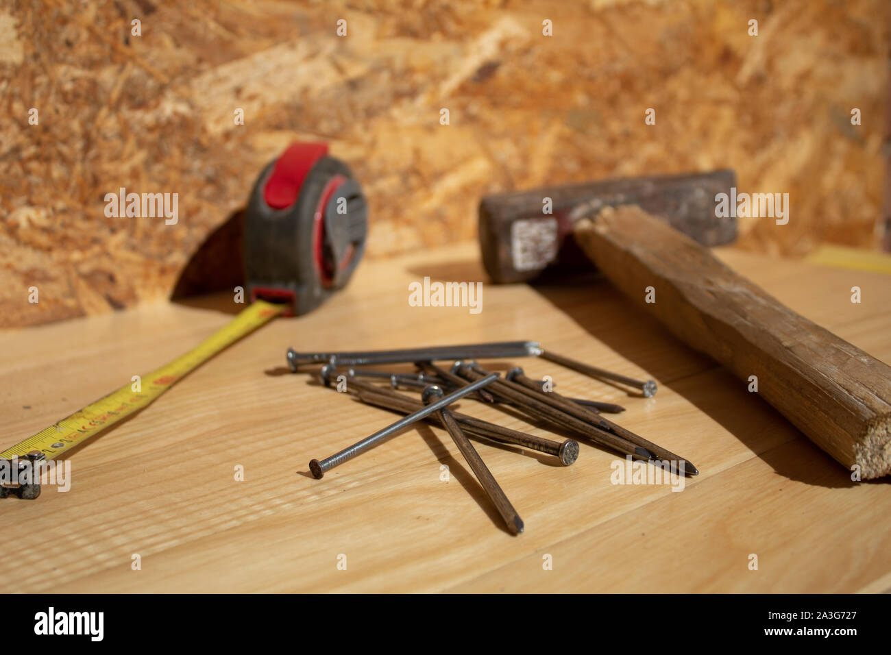 Tape measure and hammer on wood hi-res stock photography and images - Alamy