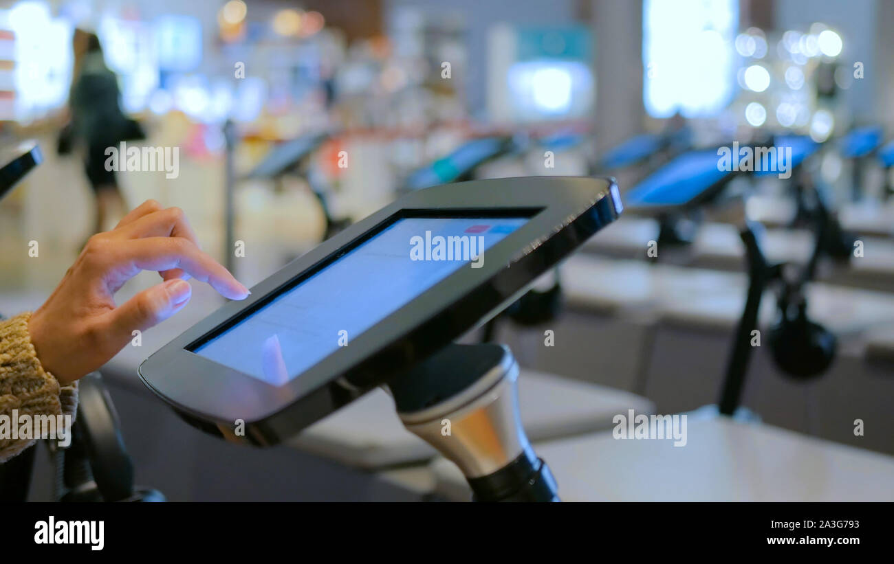 Woman using interactive display tablet at jewish modern history museum ...