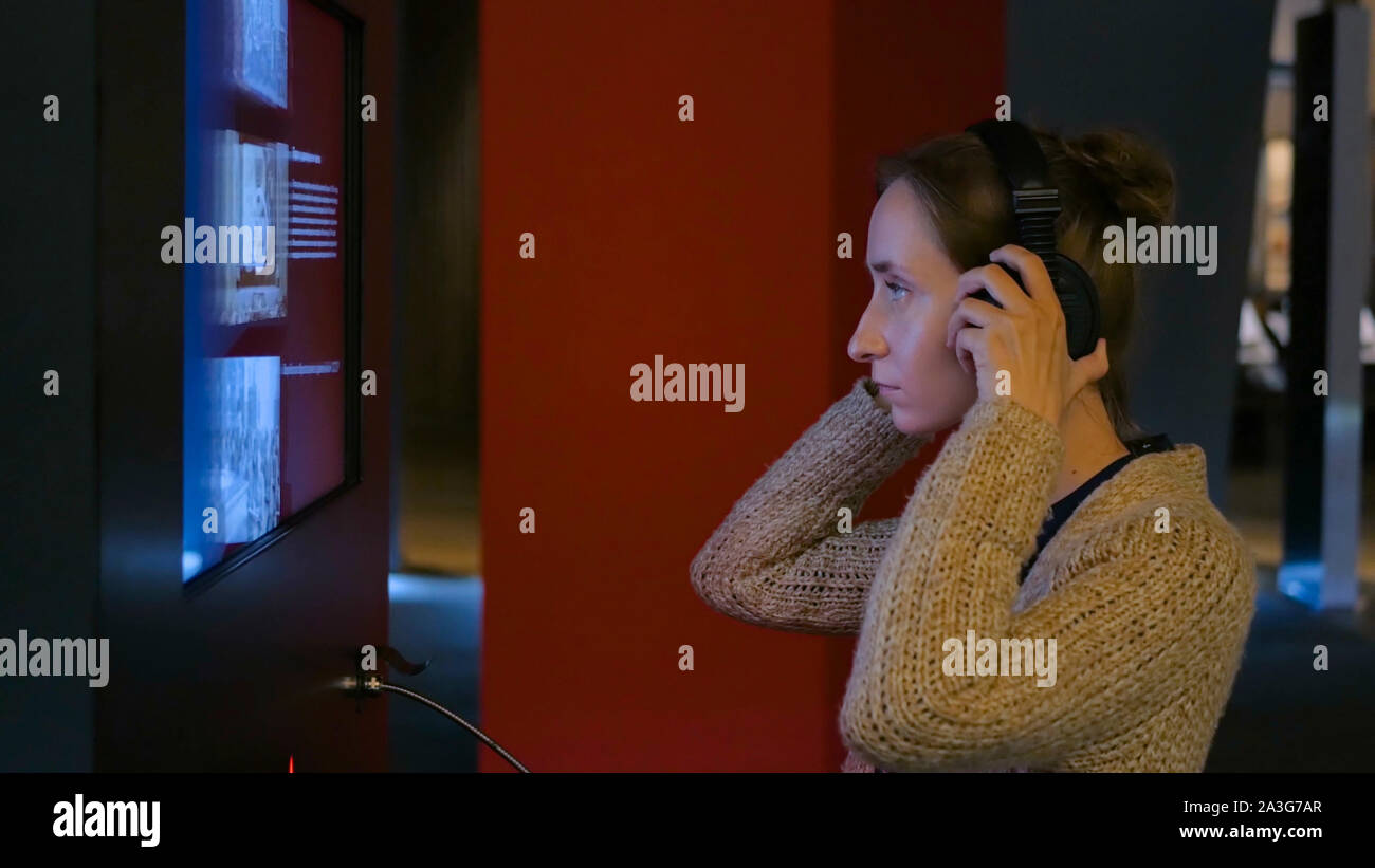 Woman listening audio guide at modern jewish history museum Stock Photo ...