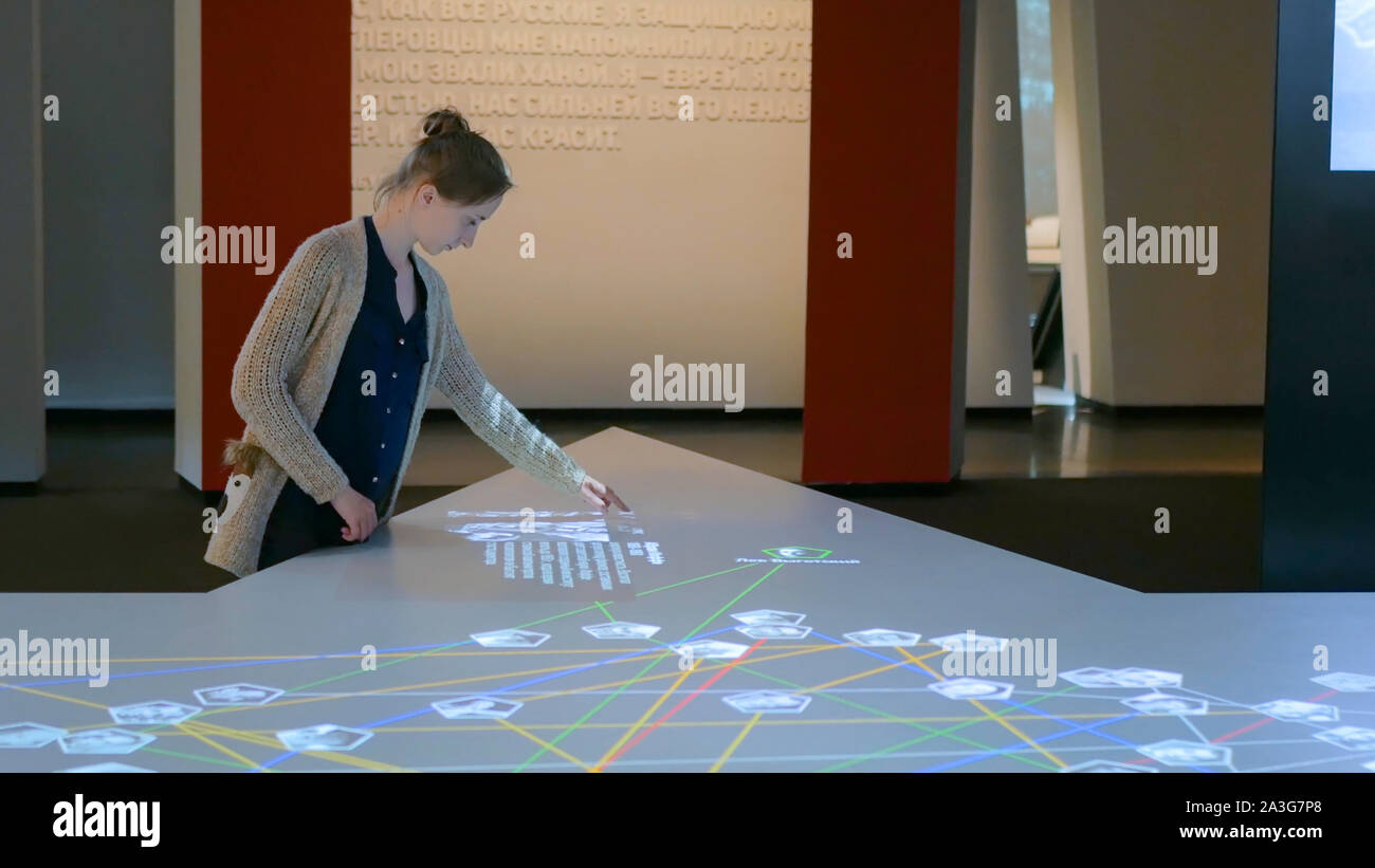 Woman using interactive touchscreen display Stock Photo - Alamy