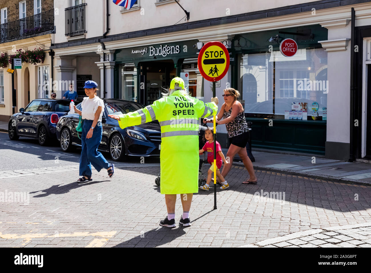 England, Berkshire, Eton, Eton High Street, Lollipop Lady Holding Stop ...