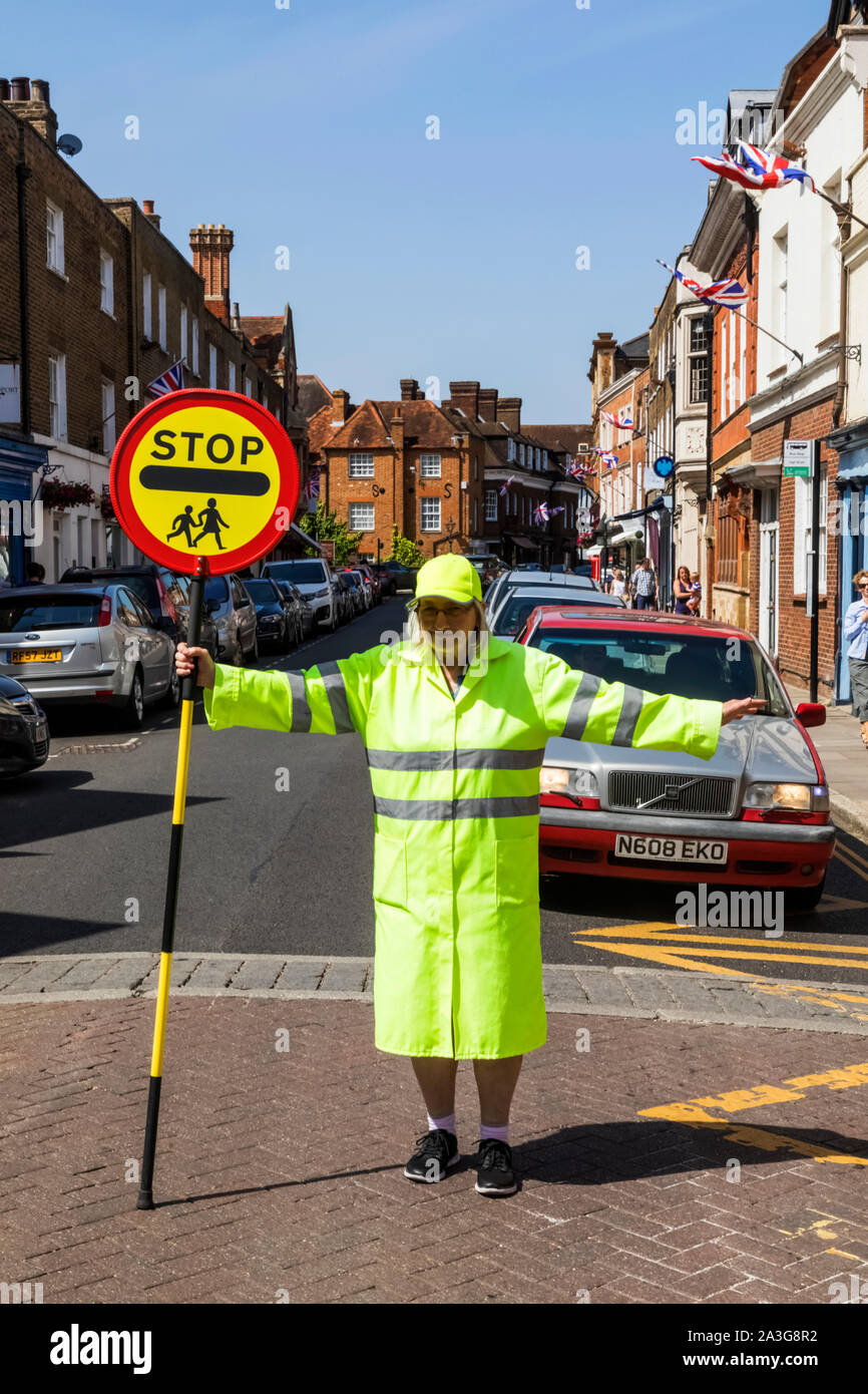 England, Berkshire, Eton, Eton High Street, Lollipop Lady Holding Stop ...